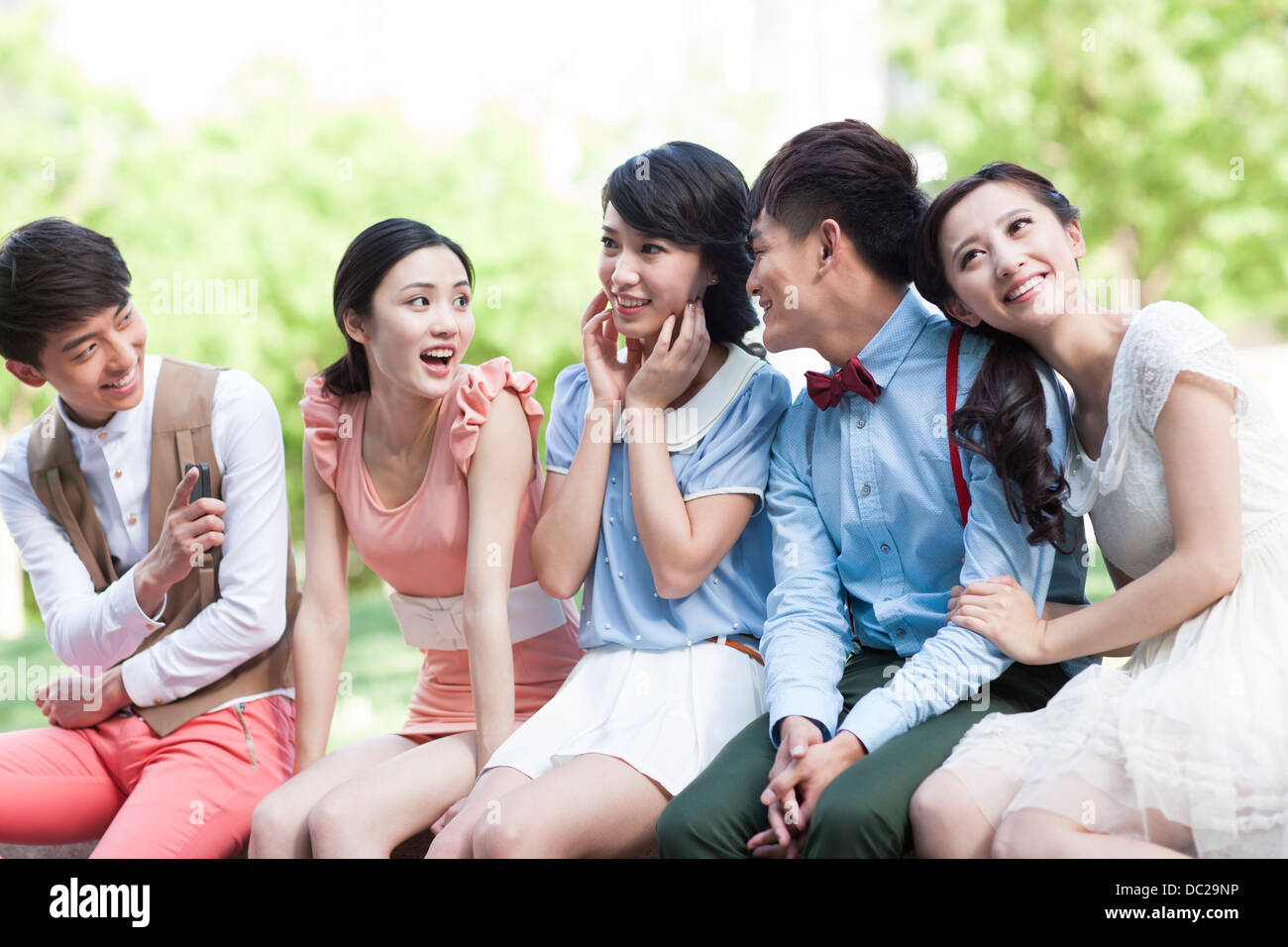 Stylish young Chinese people sitting together Stock Photo - Alamy