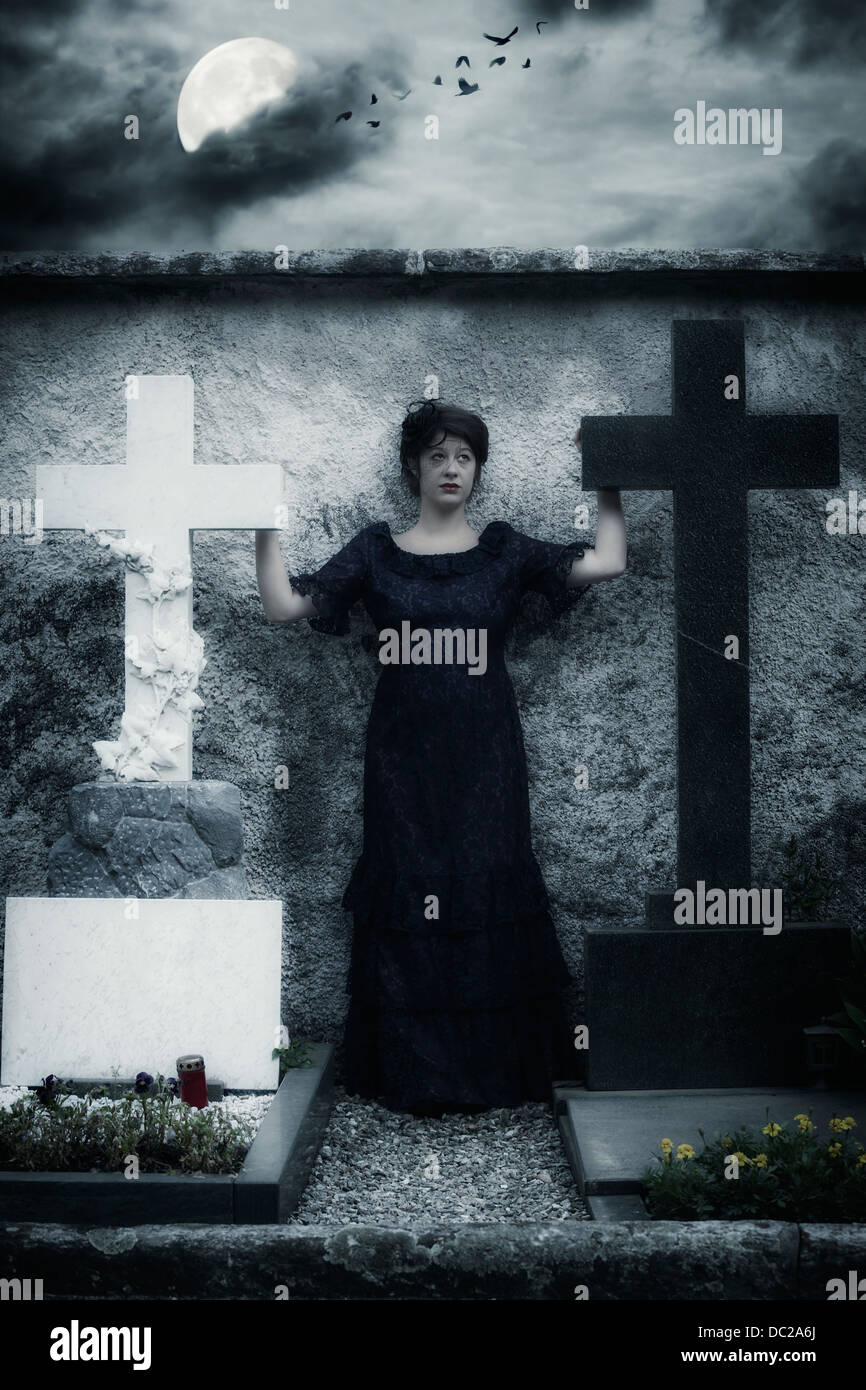 a grieving woman with veil and dark dress on a graveyard Stock Photo ...