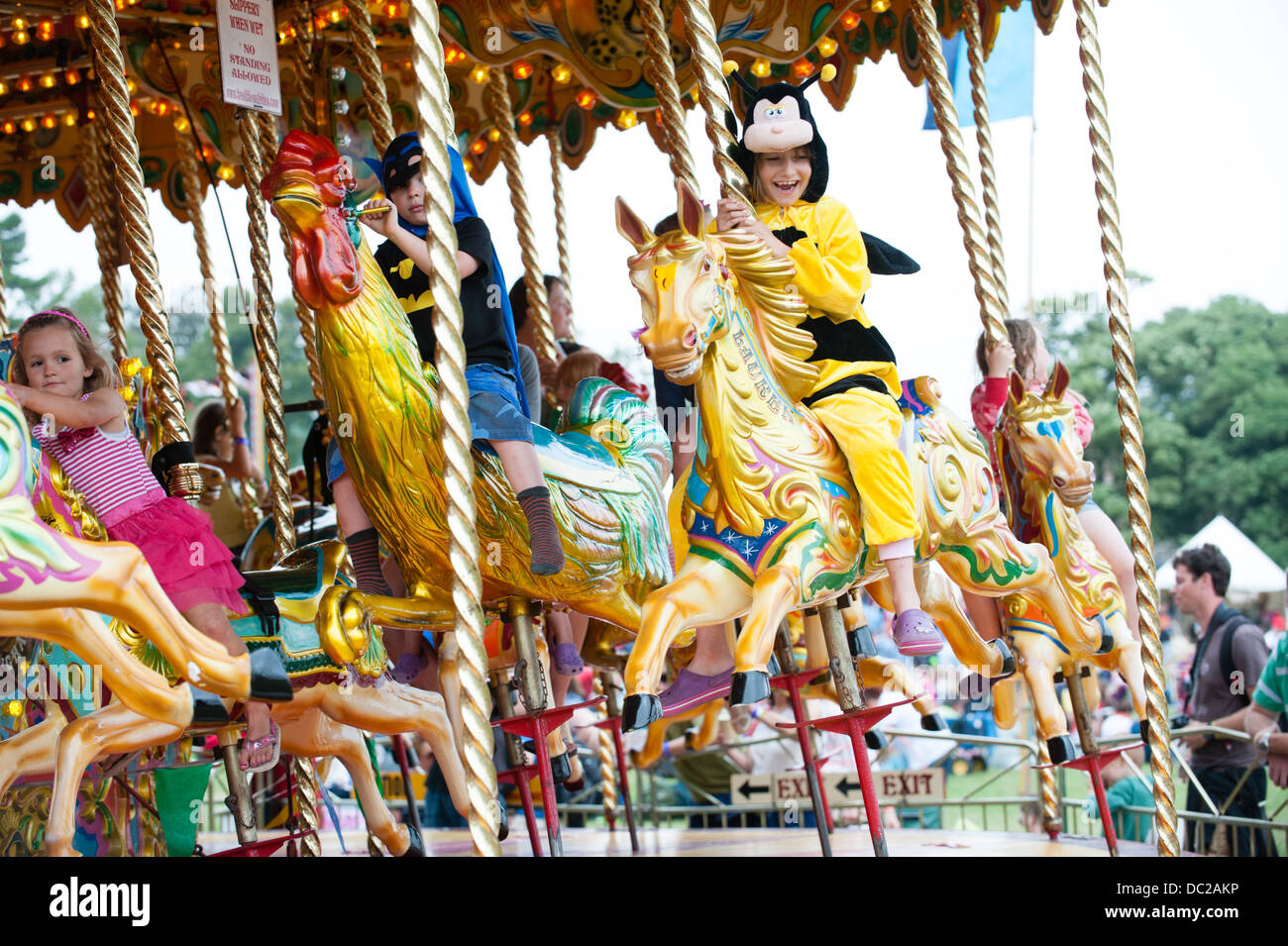 Happy, smiling young white girl in fancy dress as a bee sitting on a ...