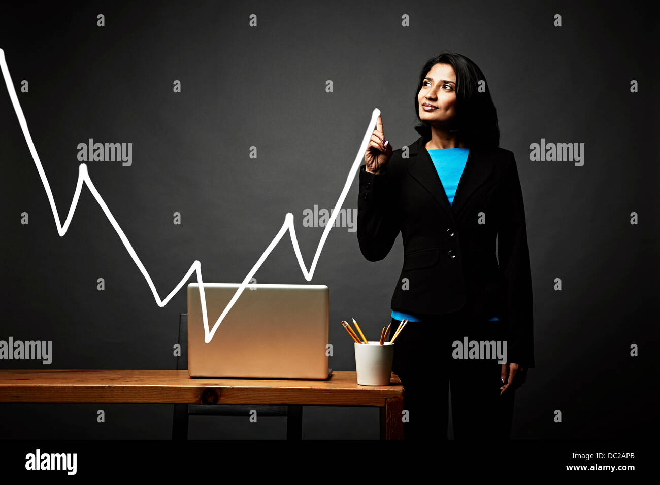 Woman drawing line graph Stock Photo - Alamy