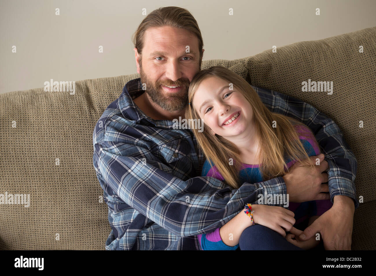 Father and daughter looking at camera Stock Photo - Alamy