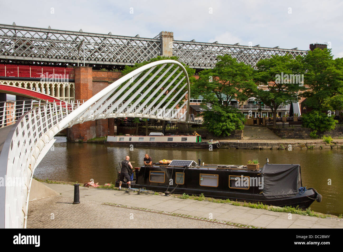 Castlefield in Manchester with canal boat, 1849 red brick viaduct and ...