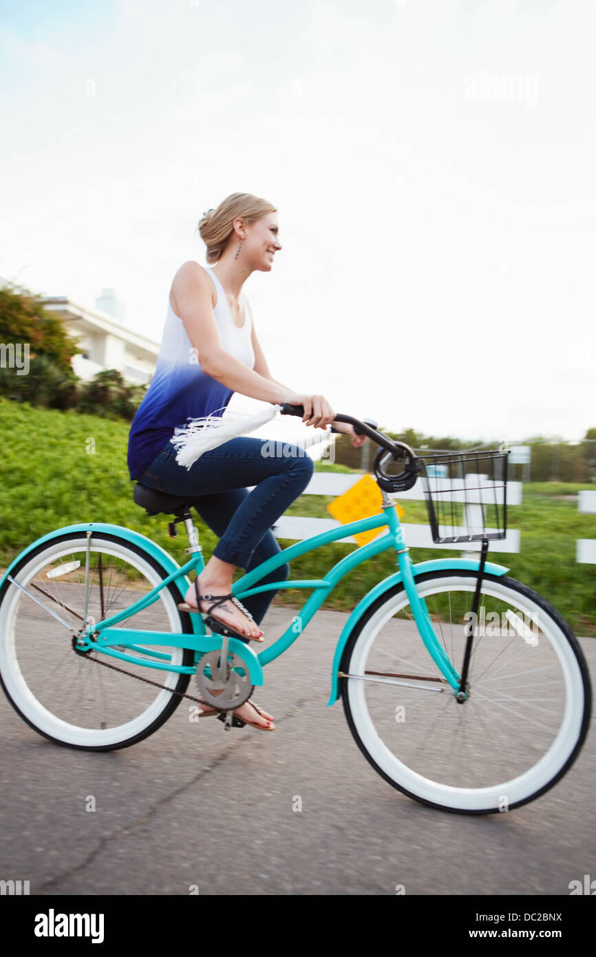 Woman riding bicycle Stock Photo - Alamy