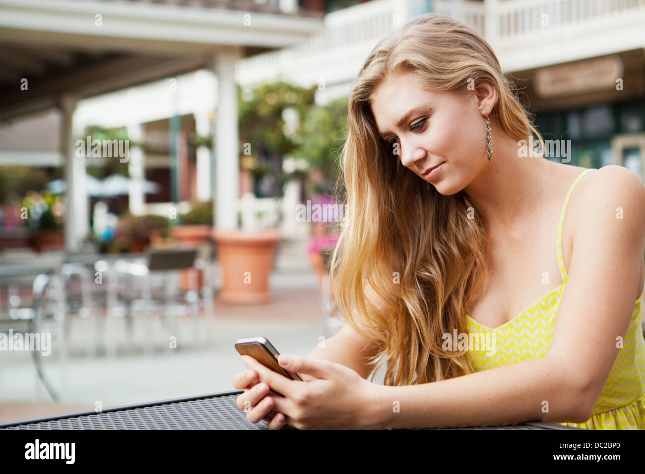 Woman looking at mobile phone Stock Photo - Alamy