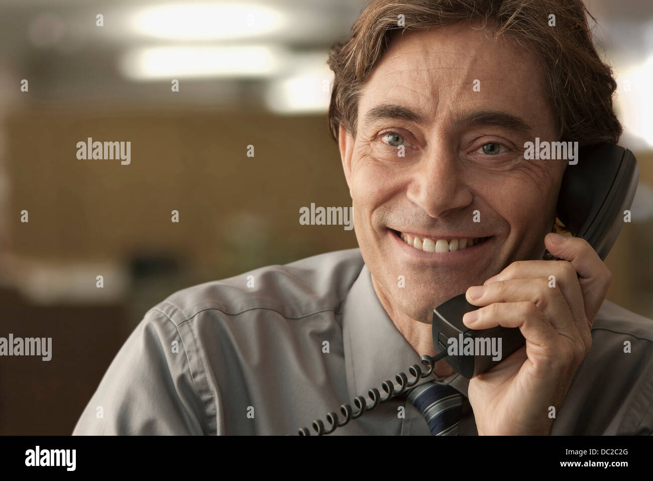 Happy man on telephone Stock Photo - Alamy