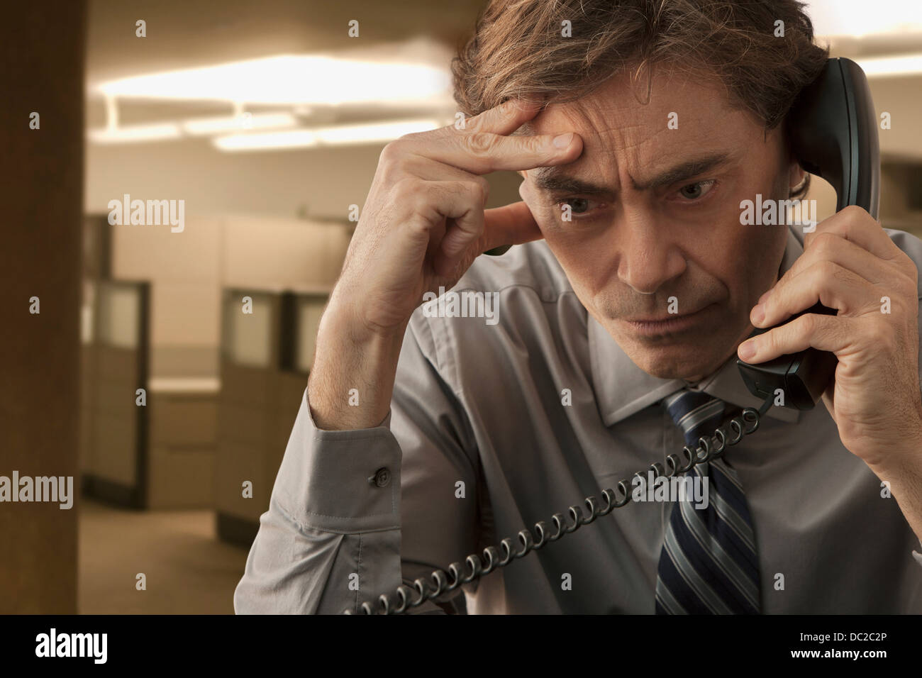 Frowning man on telephone Stock Photo - Alamy