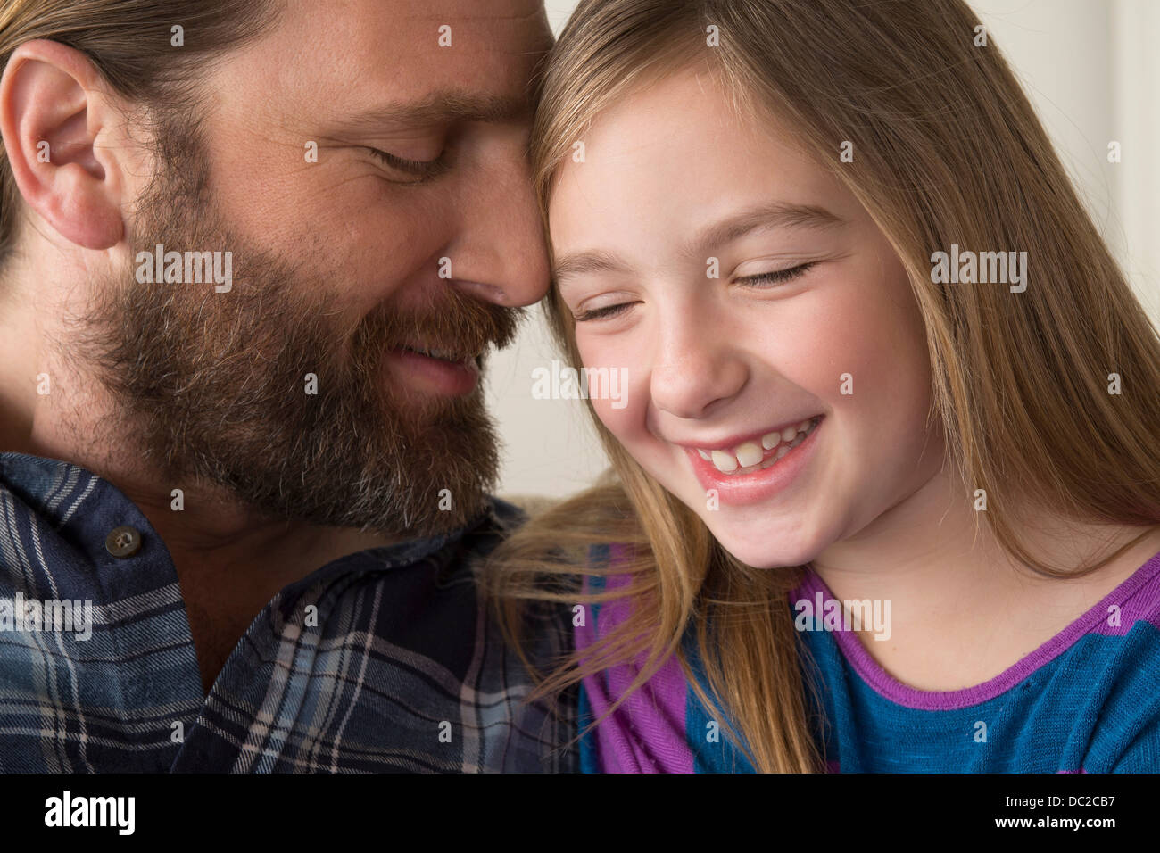 Father leaning face on daughter's head Stock Photo - Alamy