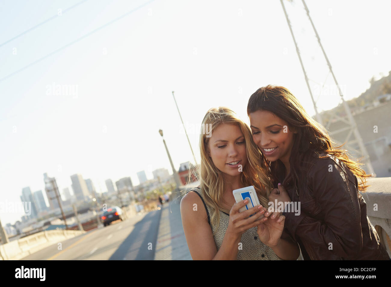 Women looking at mobile phone Stock Photo - Alamy