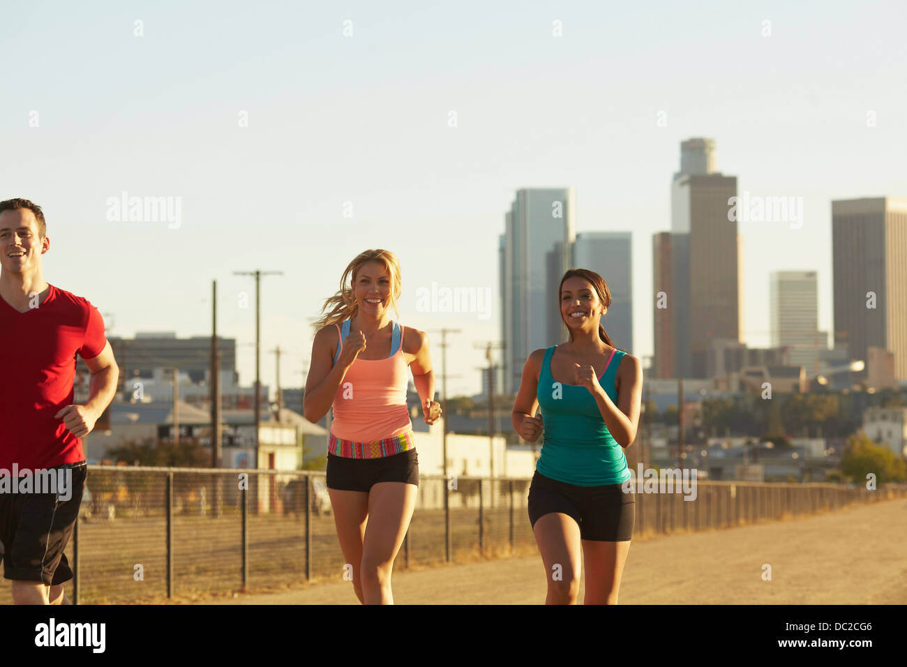 Friends jogging and laughing Stock Photo - Alamy