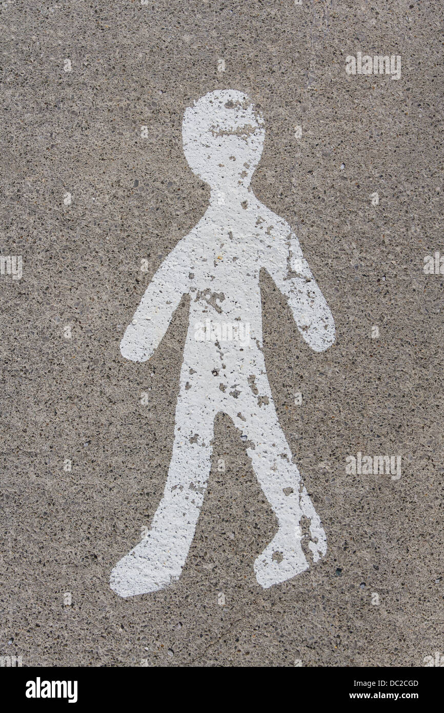 Man symbol facing left painted on a road Stock Photo - Alamy