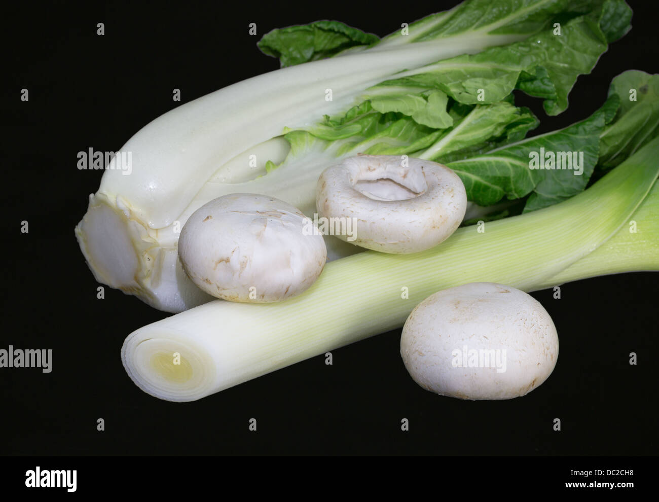 White vegetables on black background Stock Photo - Alamy