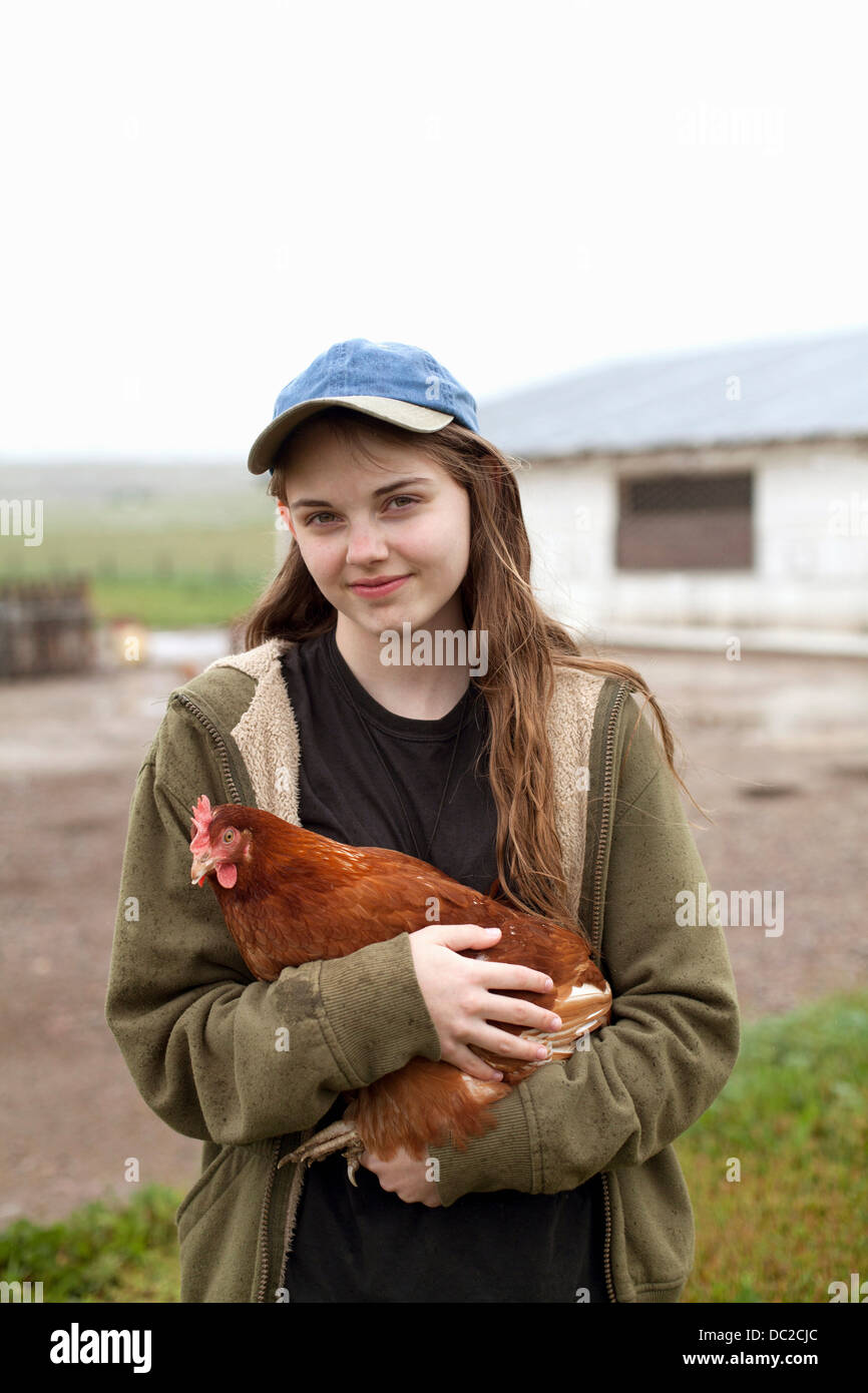 Girl carrying hen Stock Photo - Alamy