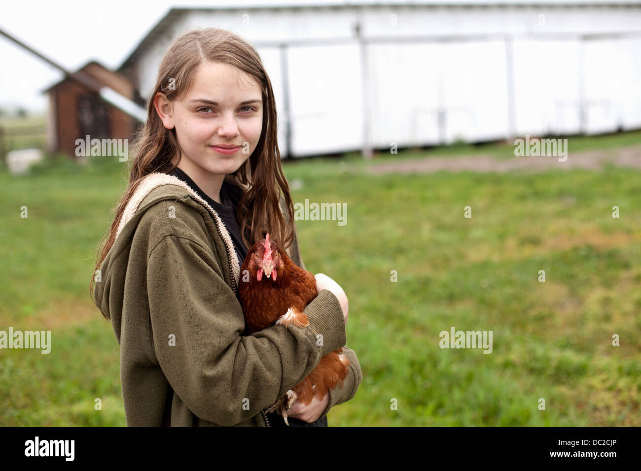 Girl carrying hen Stock Photo - Alamy