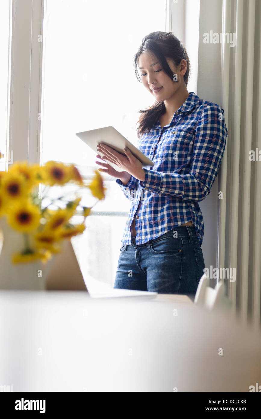 Woman standing beside window hi-res stock photography and images - Alamy