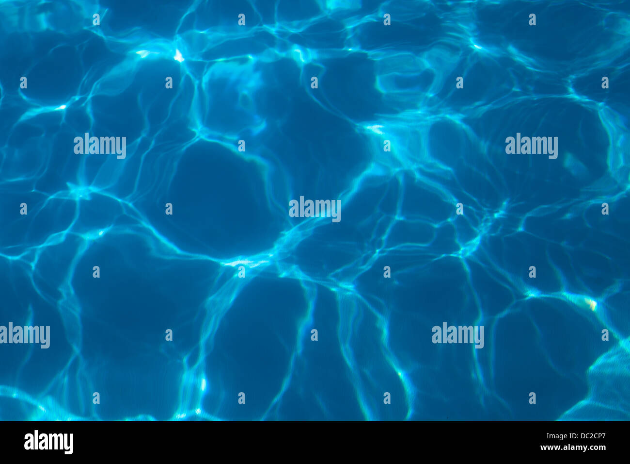 A close up of a swimming pool with the sunlight reflecting off the ...