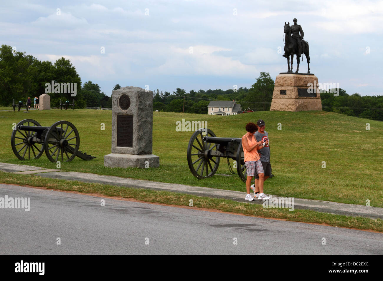 Tourists visiting Gettysburg battlefield , General Meade statue behind ...