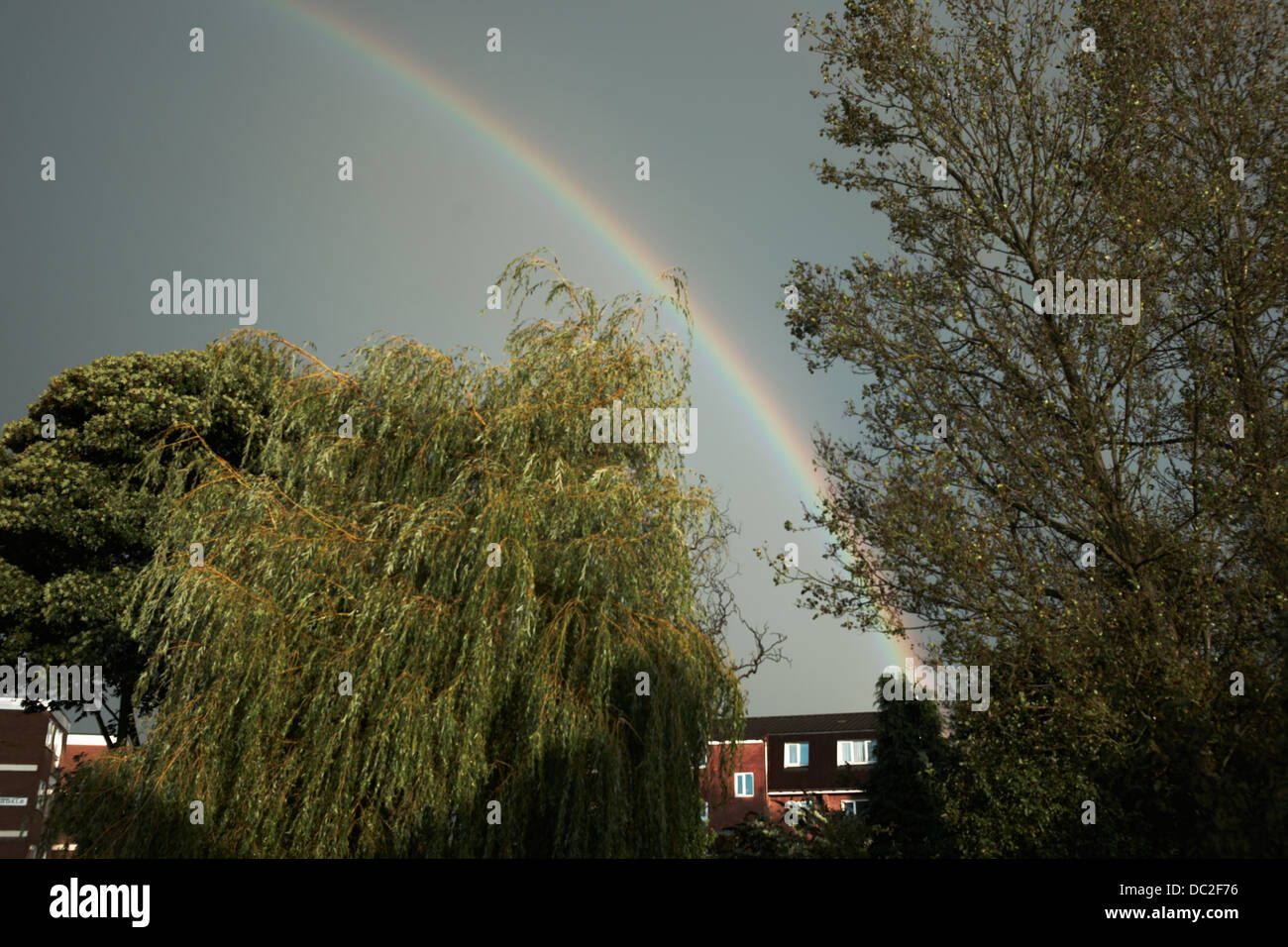 Rainbow over houses Stock Photo - Alamy