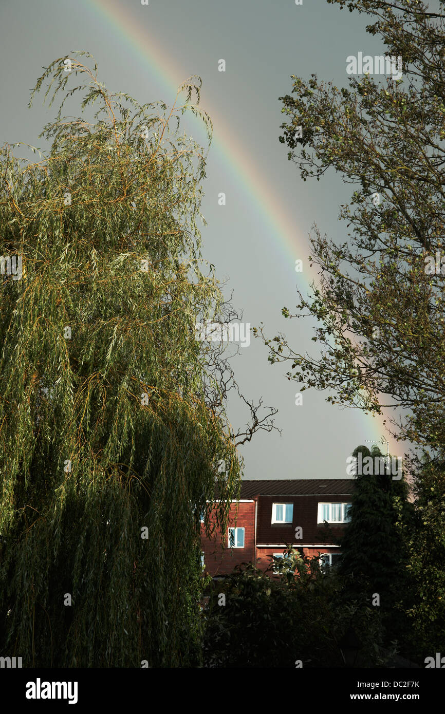 Rainbow over houses Stock Photo - Alamy
