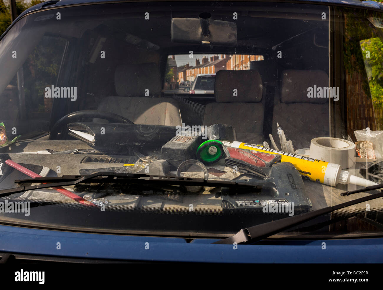 DIRTY ,DUSTY, DISORGANISED, DASH BOARD OF BUILDERS VAN WITH JUMBLE OF ...