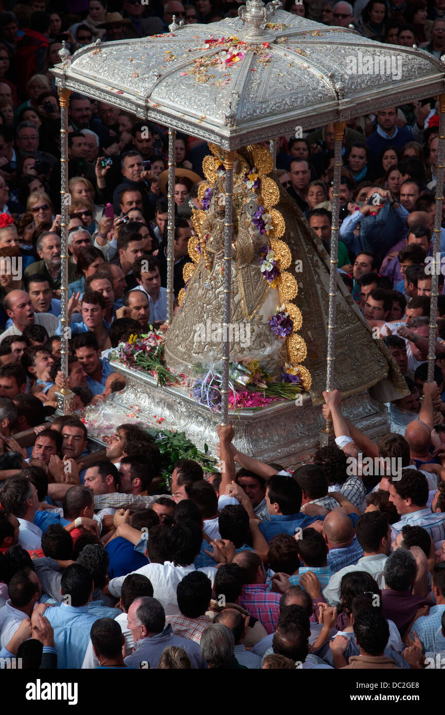 The image of Our Lady of El Rocio is carried by a crow in a procession ...