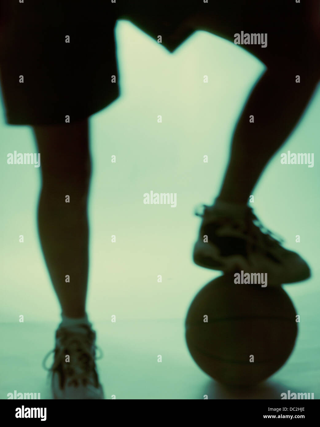 basketball player legs with foot on ball model release. ©mak Stock ...