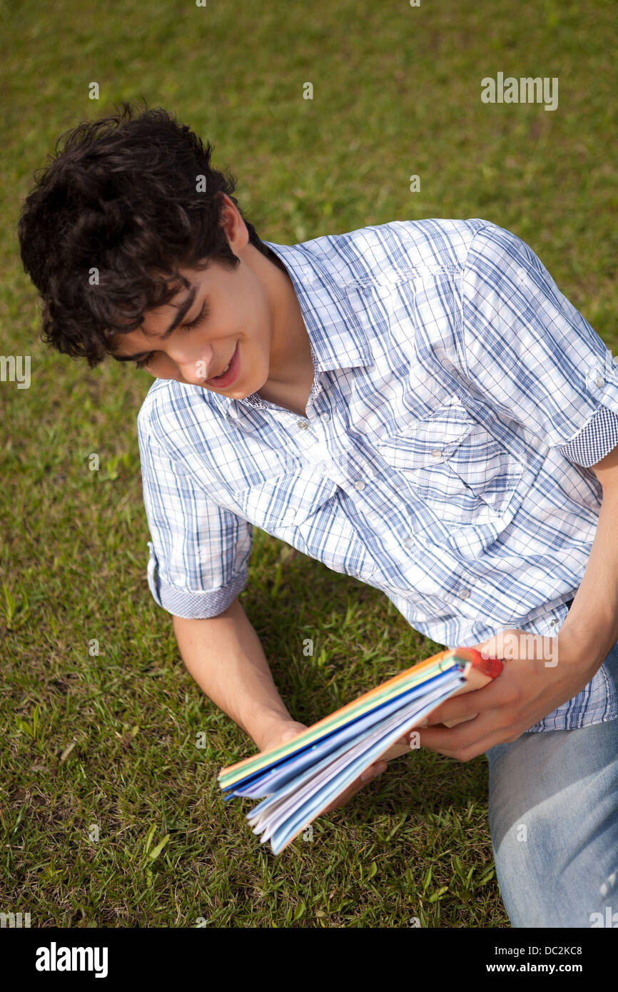 Young boy studying at the park Stock Photo - Alamy