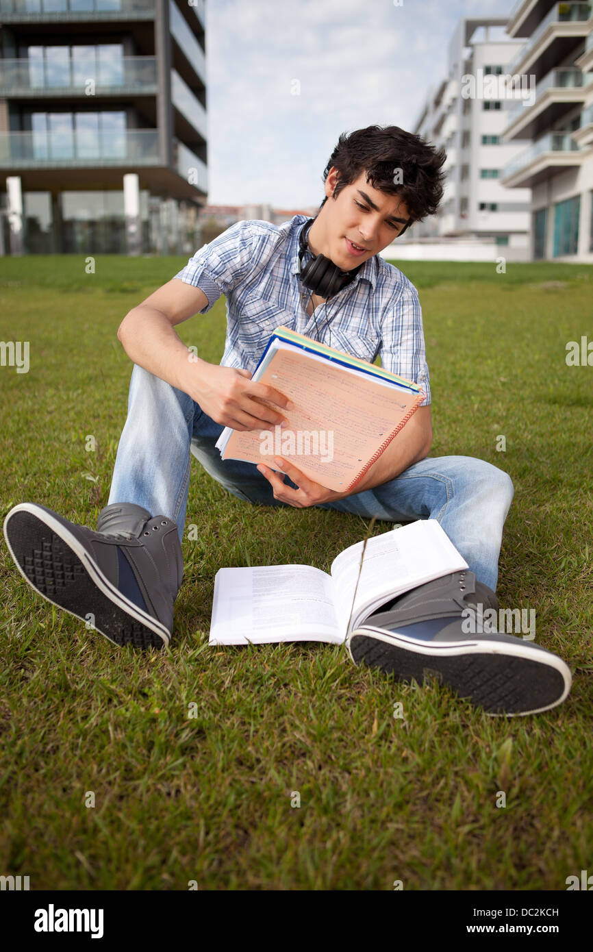 Young boy studying at the park Stock Photo - Alamy