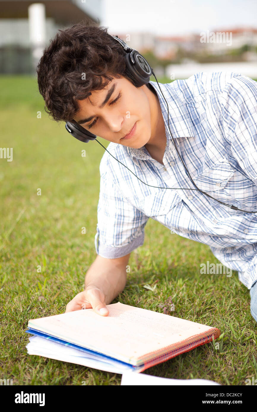 Young boy studying at the park Stock Photo - Alamy