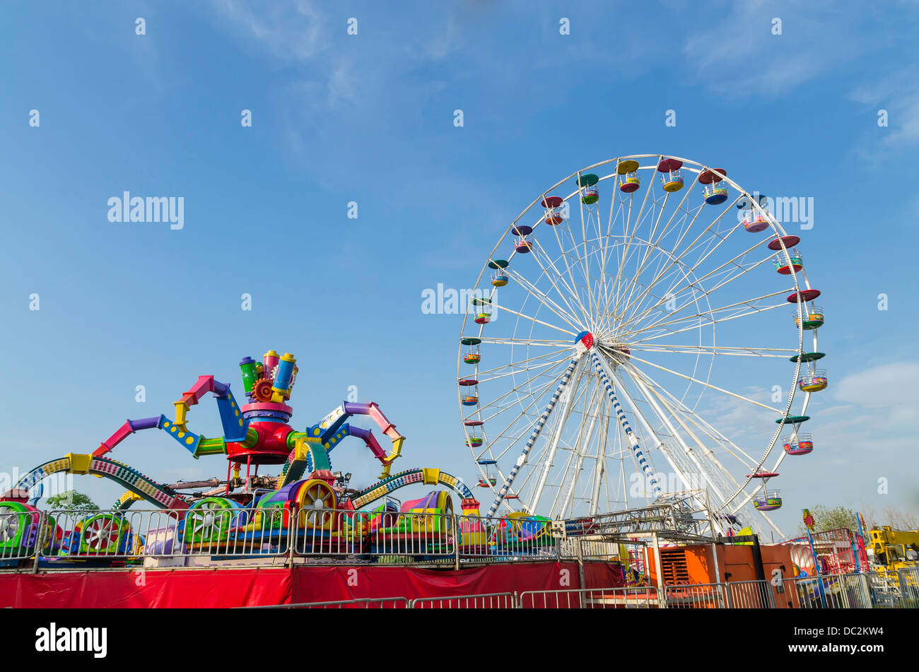 amusement park rides with blue sky background Stock Photo - Alamy
