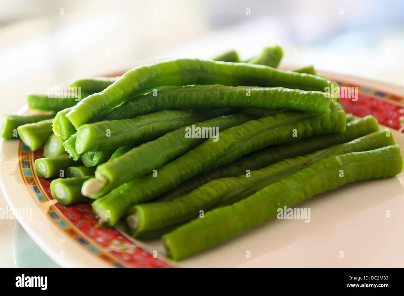 long green bean on a plate in a restaurant Stock Photo - Alamy