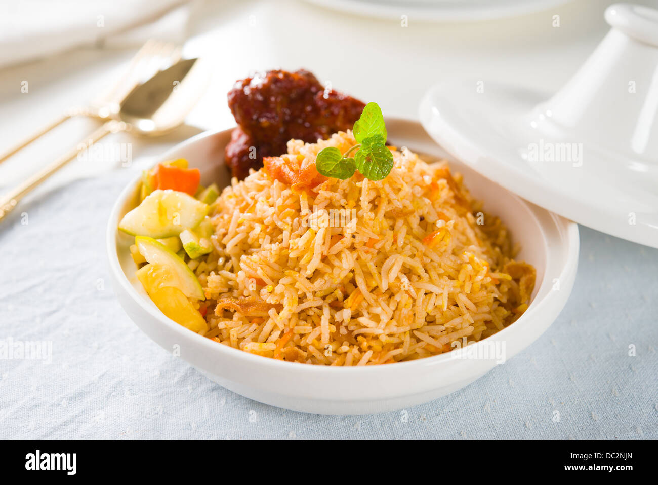 Biryani rice or briyani rice, curry chicken and salad, traditional ...