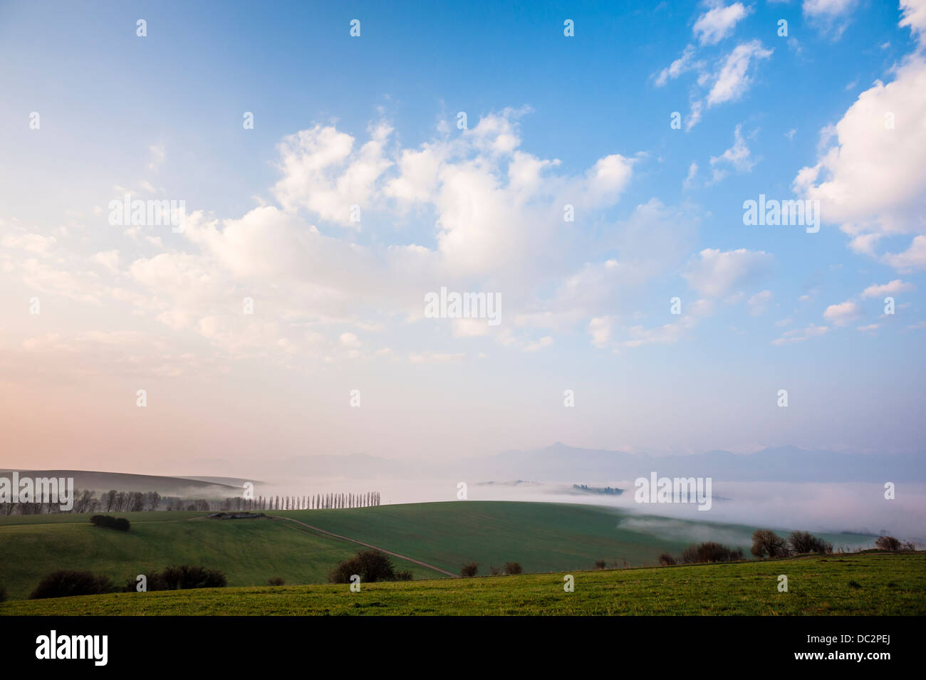 spring sunrise over meadows with clouds and fog Stock Photo - Alamy