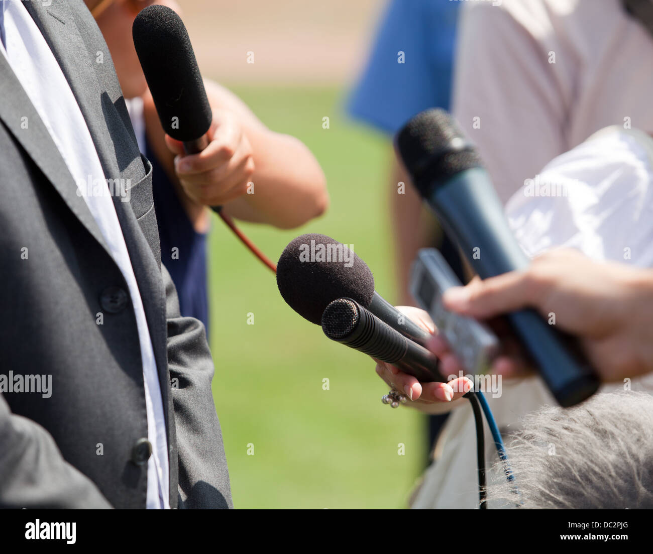 A journalist is making a interview with a microphone Stock Photo - Alamy