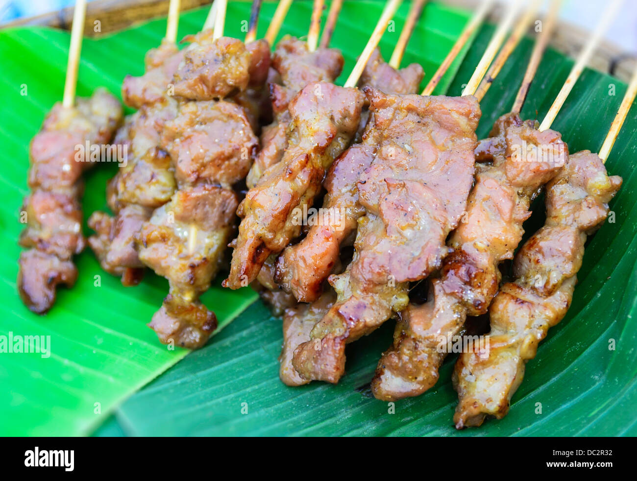 Pig roasting on a banana leaf Stock Photo - Alamy