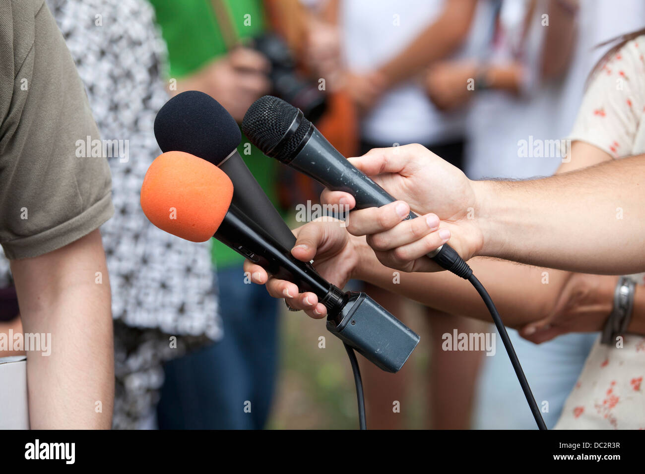 A journalist is making a interview with a microphone Stock Photo - Alamy