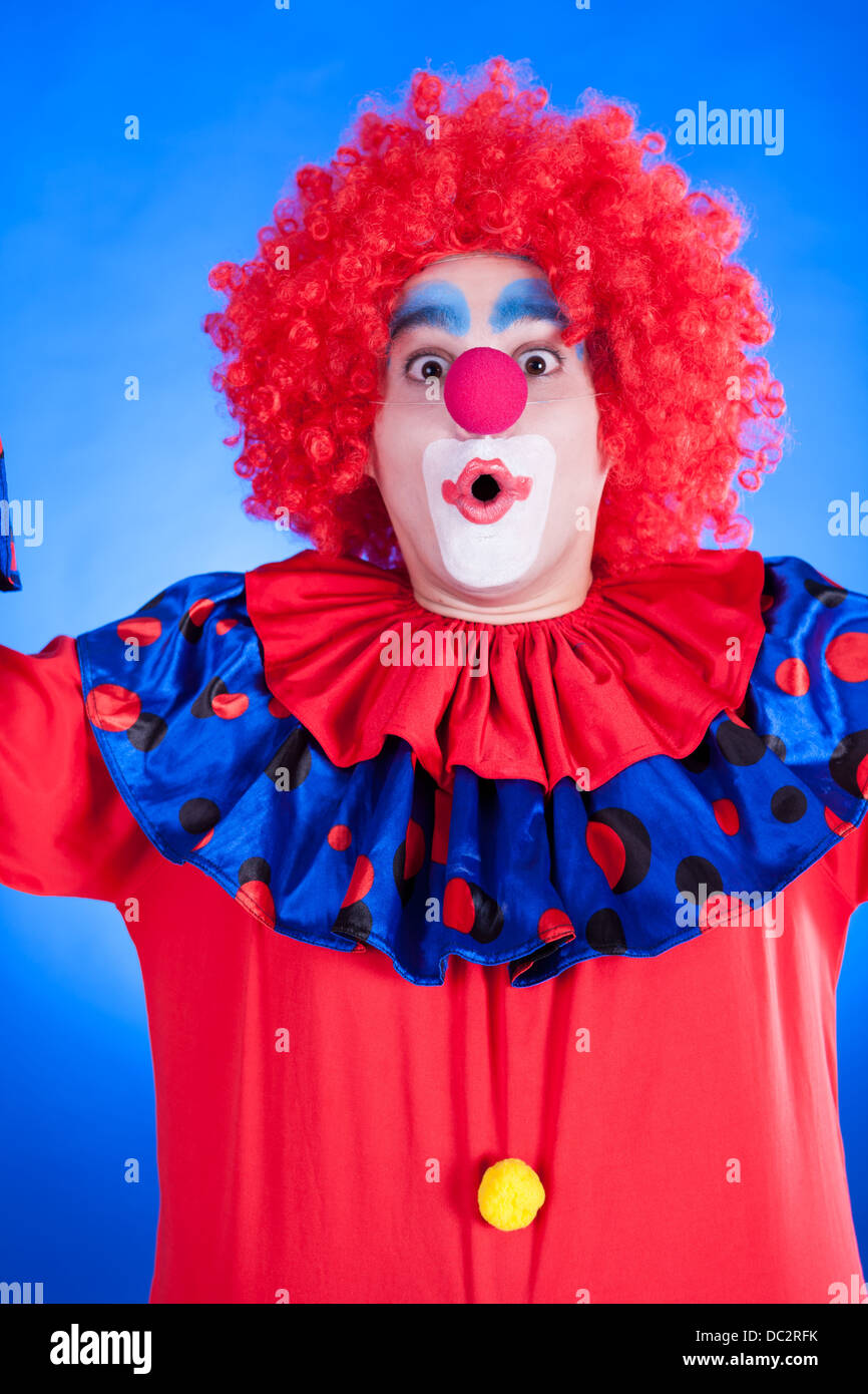 Clown on blue backgound studio inside shot Stock Photo - Alamy