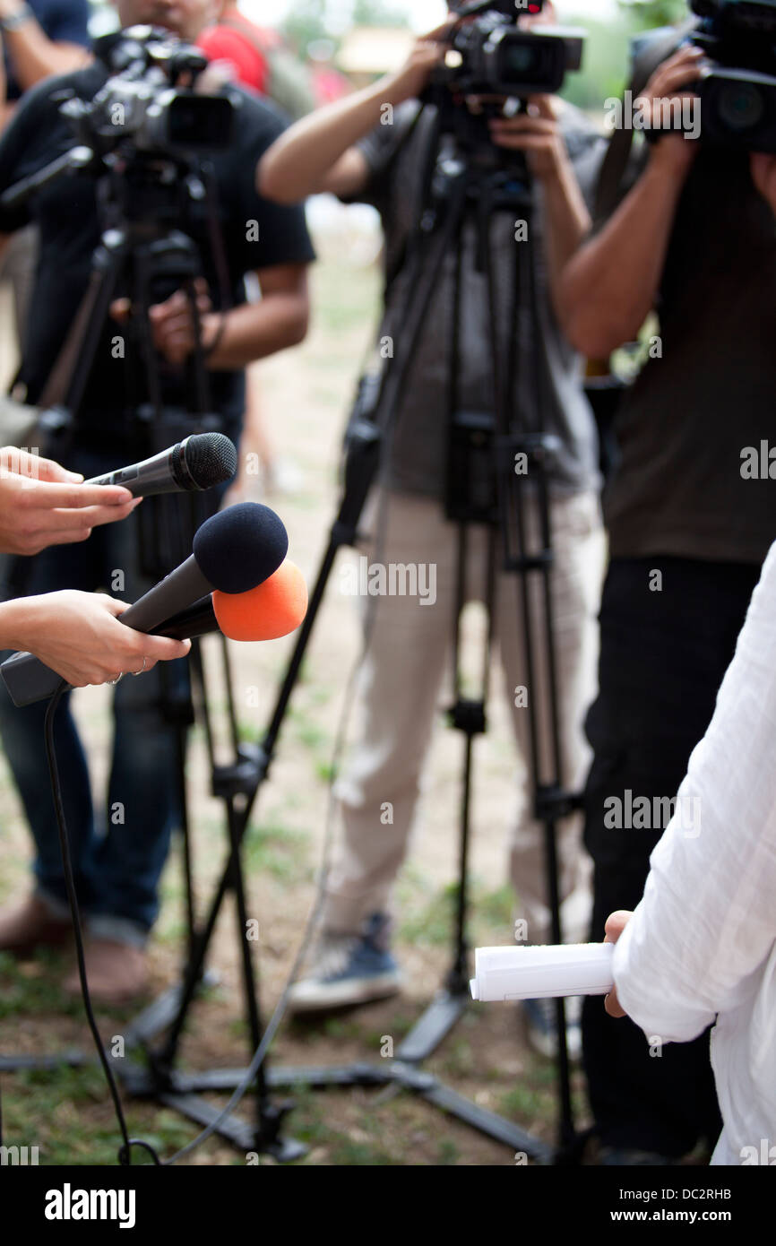 A journalist is making a interview with a microphone Stock Photo - Alamy