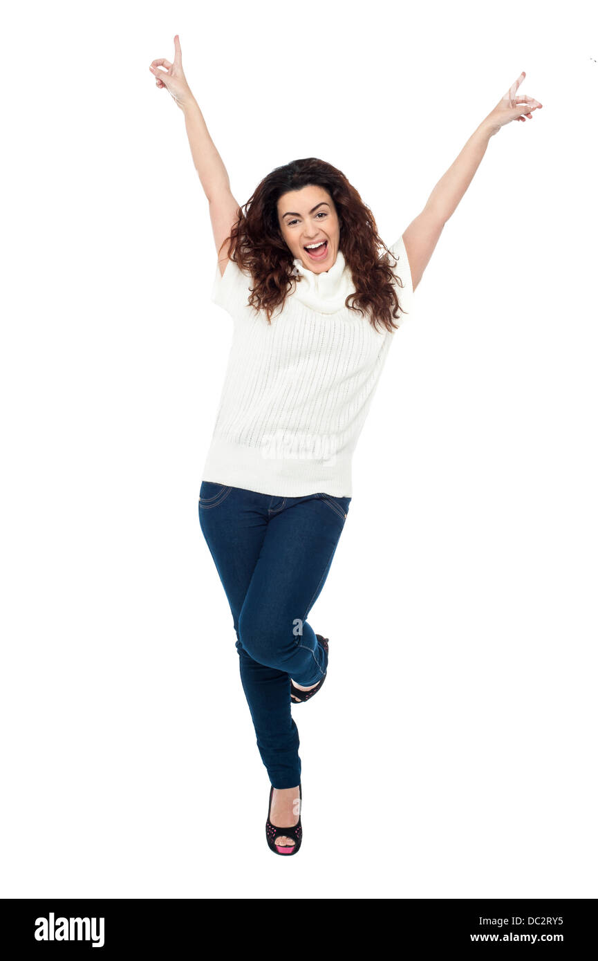 Joyous woman dancing with arms raised Stock Photo - Alamy