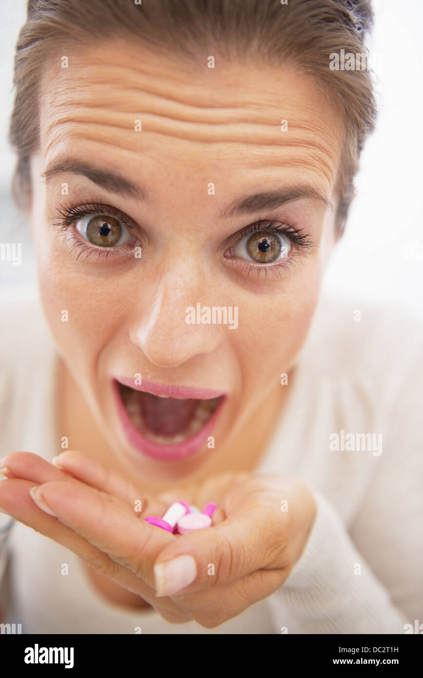 Closeup on mad woman eating handful of pills Stock Photo - Alamy