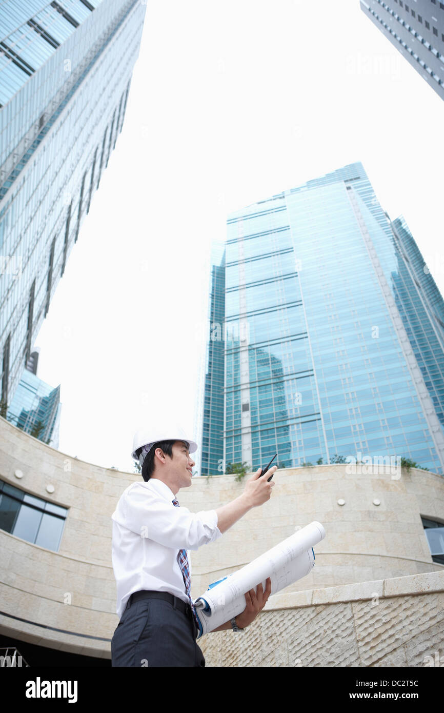 construction working in front of office buildings Stock Photo - Alamy