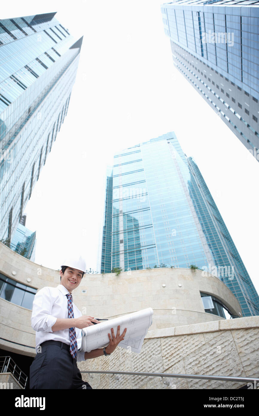 construction working in front of office buildings Stock Photo - Alamy