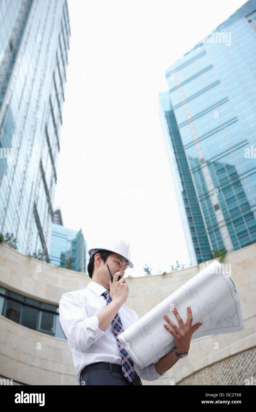 construction working in front of office buildings Stock Photo - Alamy