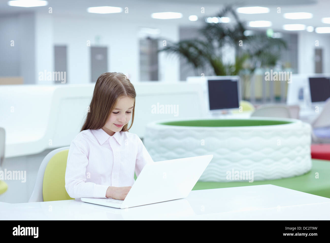 a girl using a laptop Stock Photo - Alamy