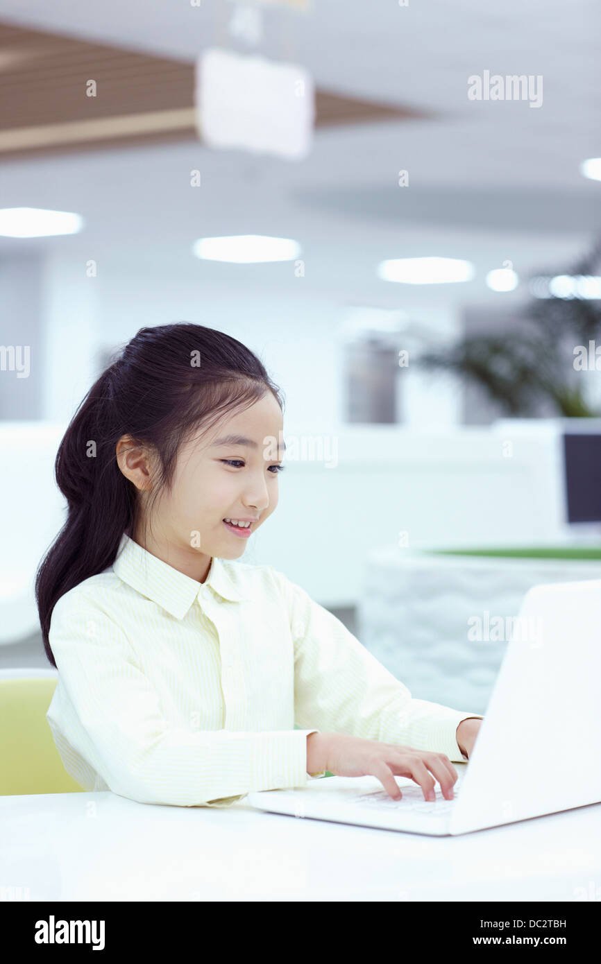 a girl using a laptop Stock Photo - Alamy