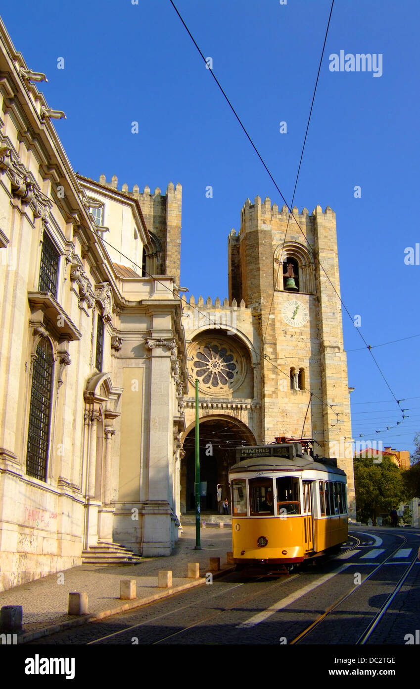 Lisbon tram passing church with overhead wires and blue sky Stock Photo ...