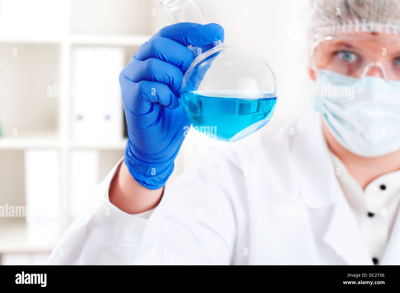 female chemist mixing liquids in test tubes Stock Photo - Alamy