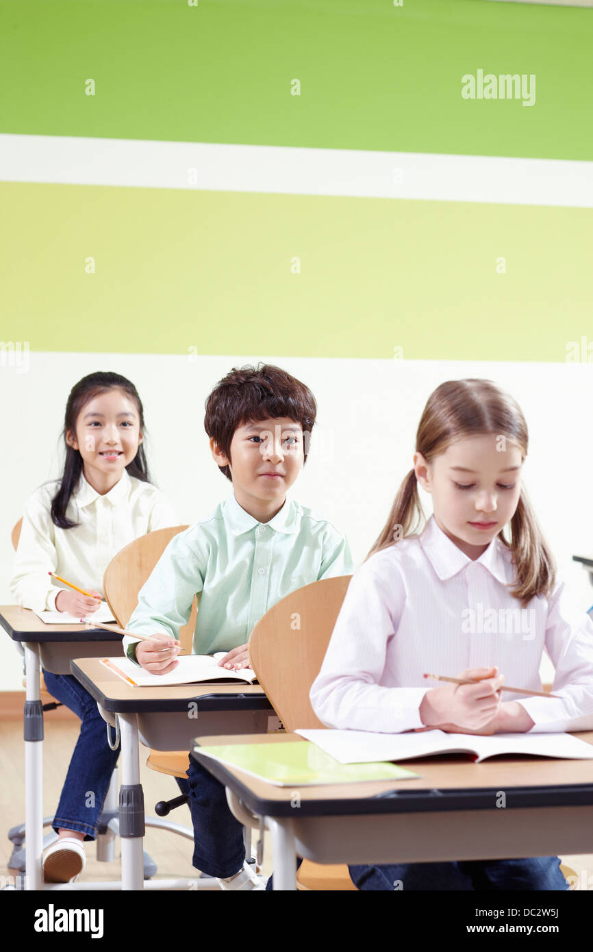 kids in a classroom sitting in a line Stock Photo - Alamy