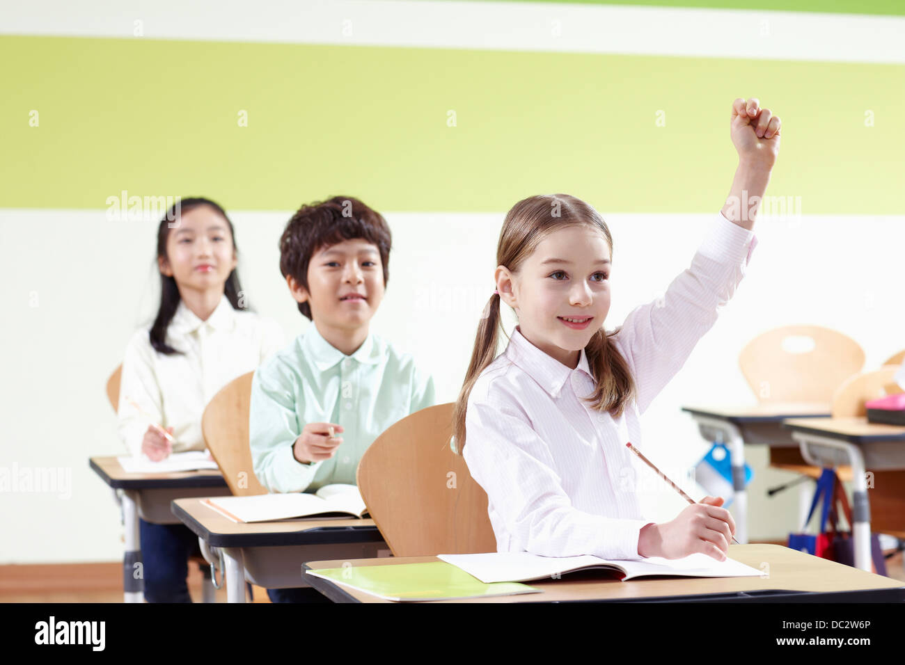 kids in a classroom sitting in a line Stock Photo - Alamy