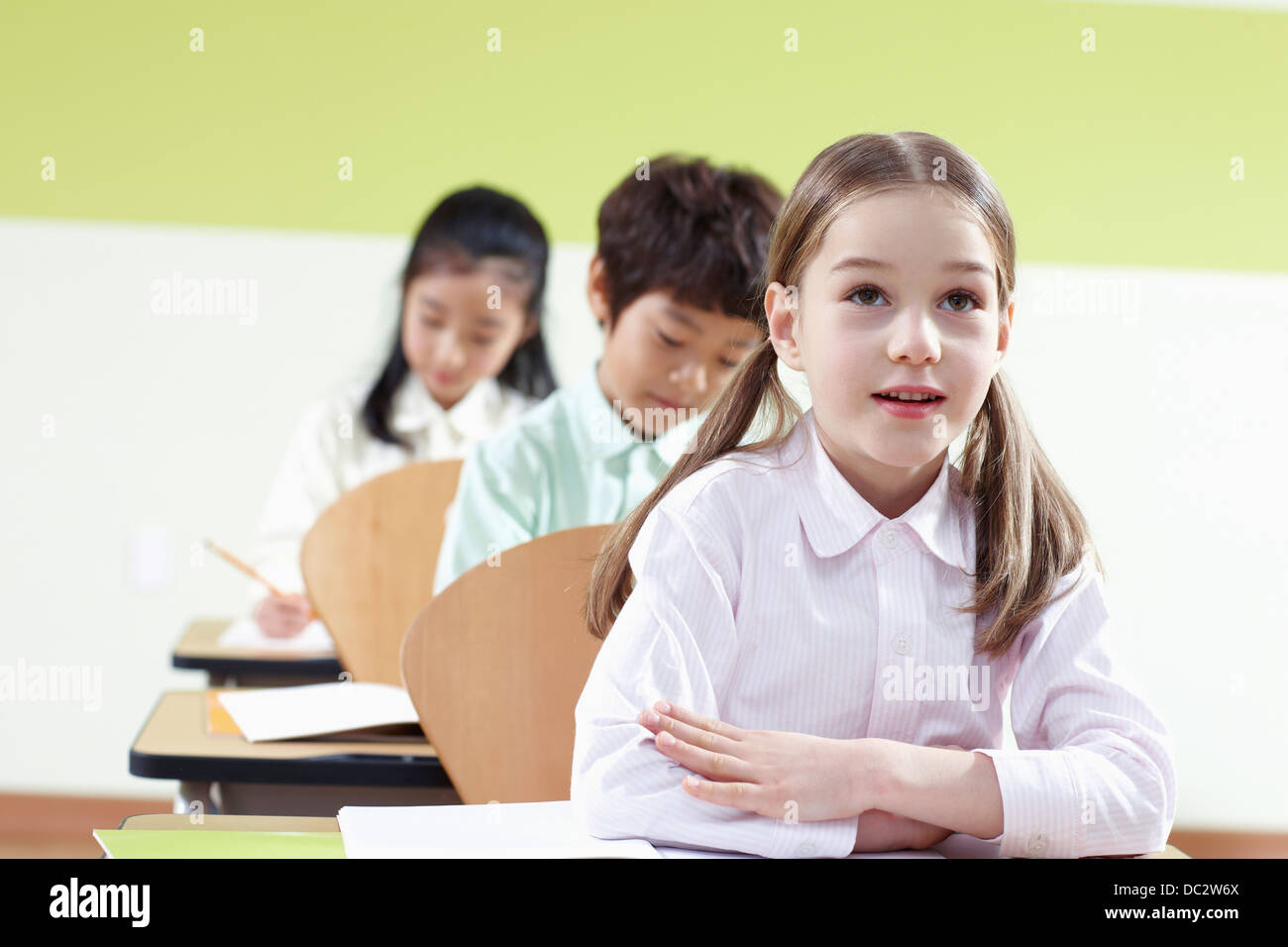 kids in a classroom sitting in a line Stock Photo - Alamy