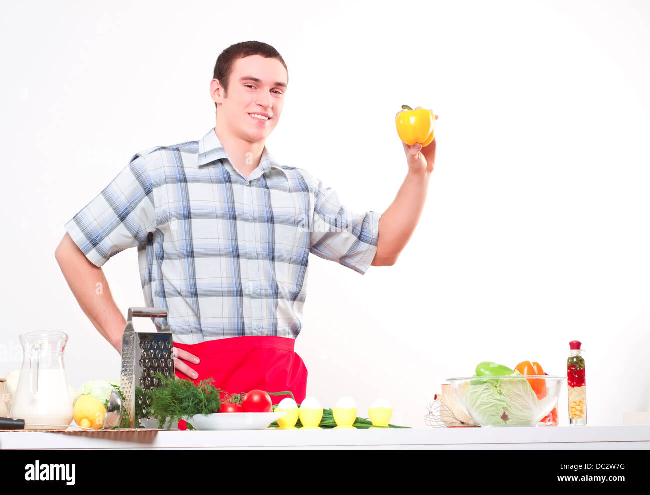 portrait of a young man with bell pepper Stock Photo - Alamy